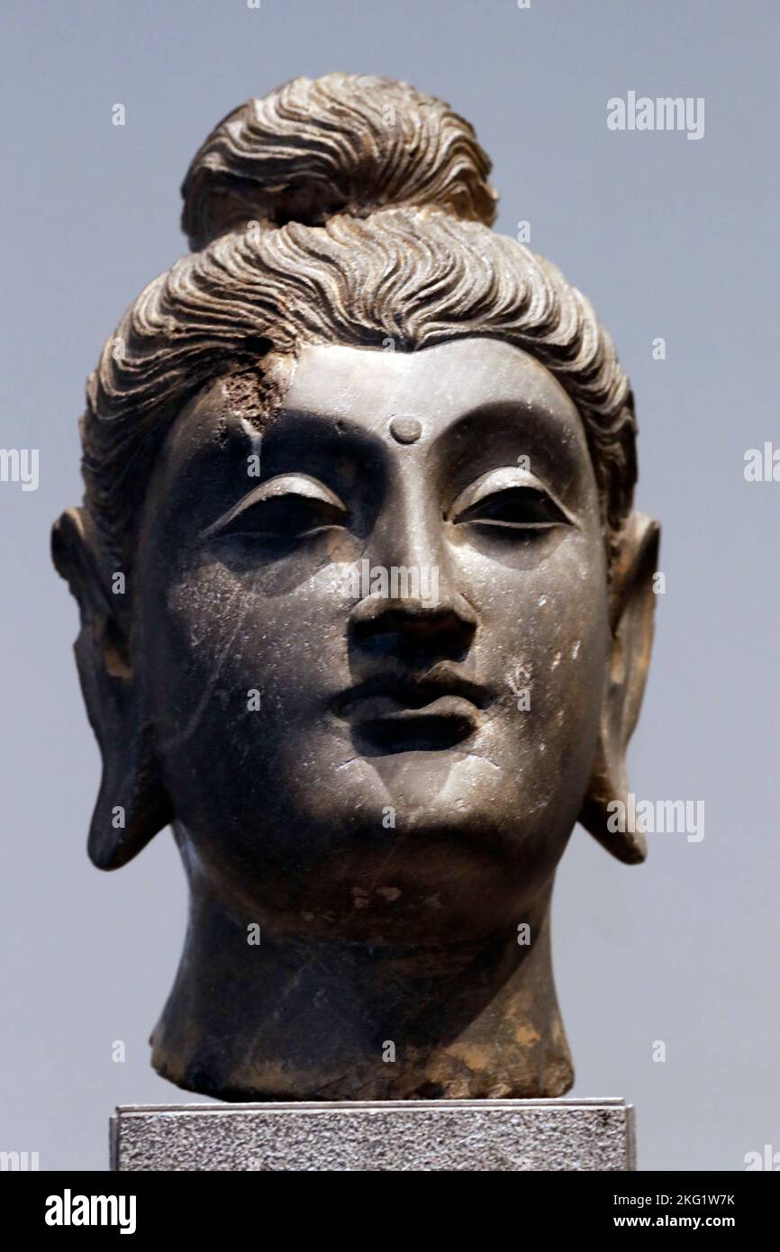 Louvre Abu Dhabi art and civilisation museum. Buddha head. Shist ...