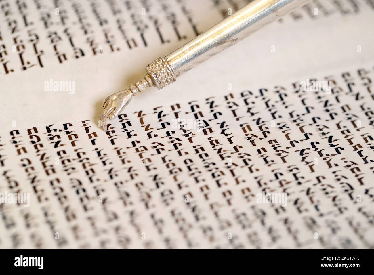 Close-up detail of traditional Torah scroll book and yad in Synagogue ...