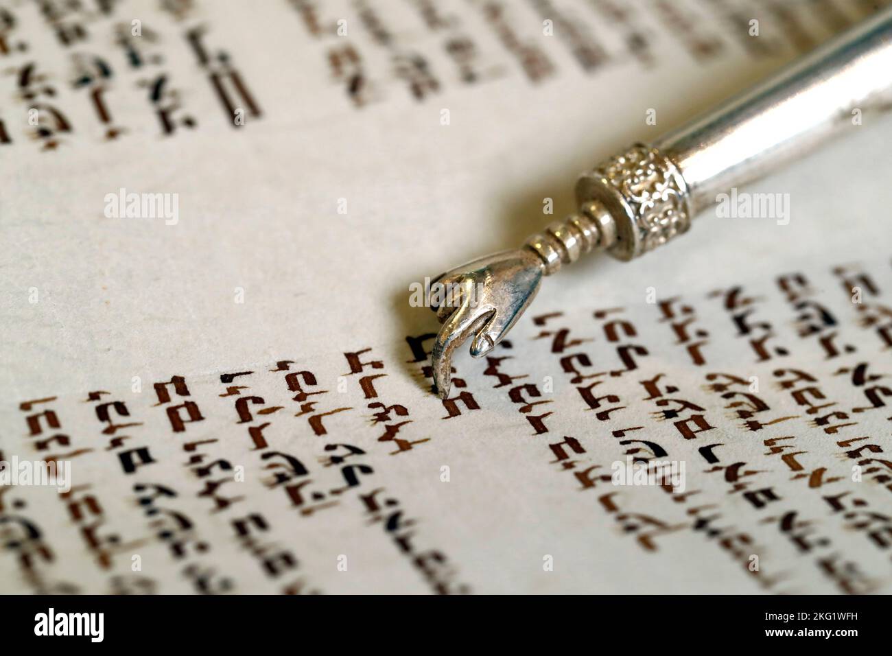 Close-up detail of traditional Torah scroll book and yad in Synagogue ...