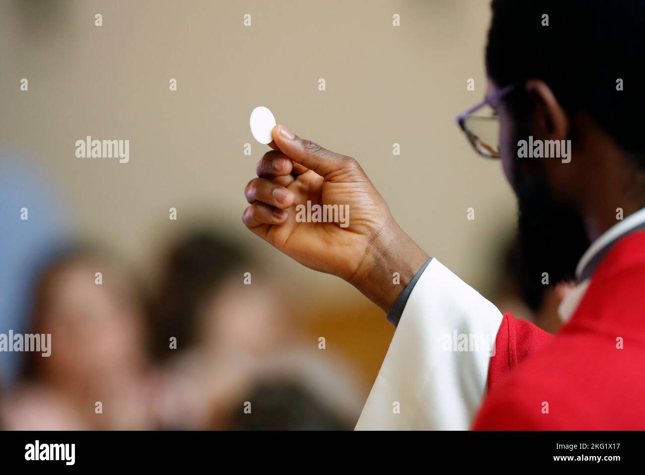 Sunday mass in a catholic parish. Priest giving Holy Communion ...