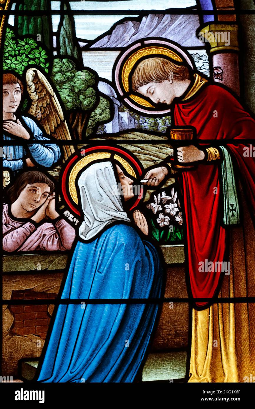 Stained glass window. The holy communion and the Virgin Mary ...