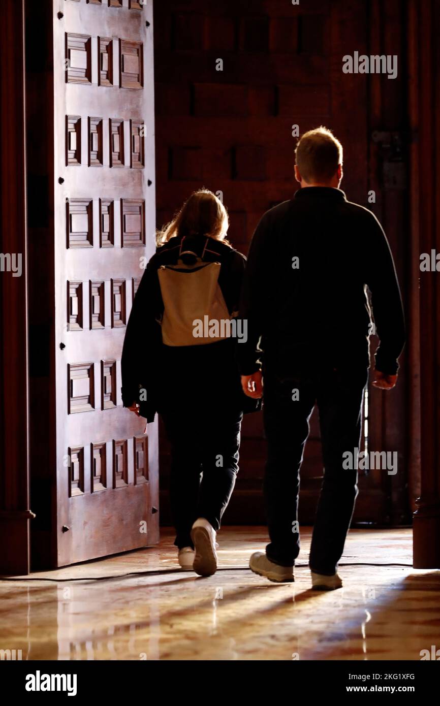 Malaga cathedraL. Open church door. Back view of christian couple ...