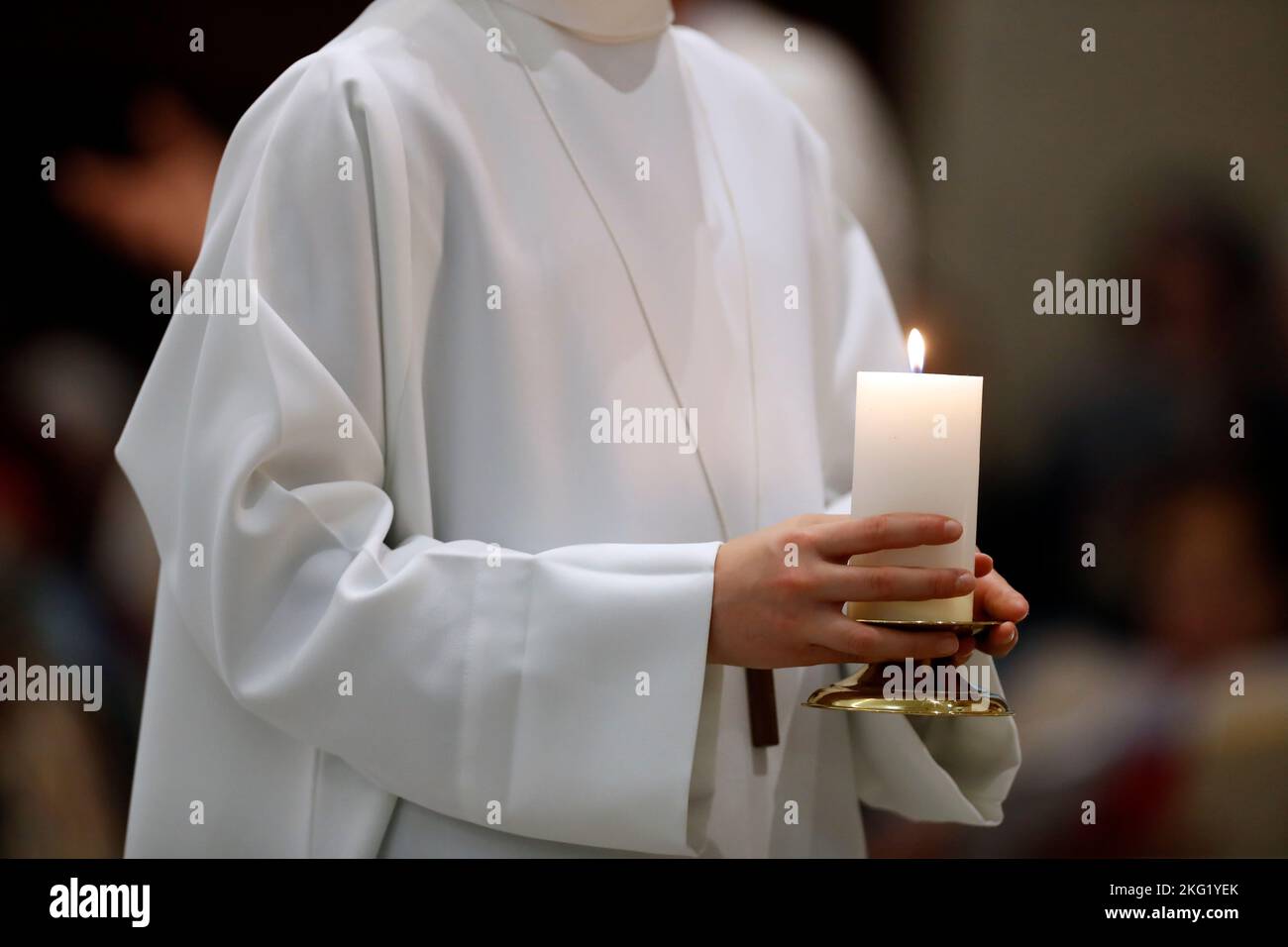 Altar boy with a church candel. Catholic mass. France Stock Photo - Alamy