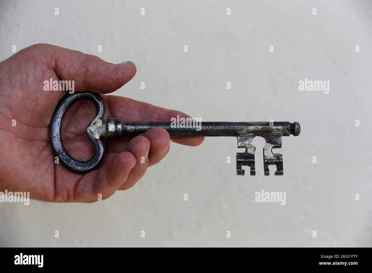 Hand holding an old key Stock Photo - Alamy