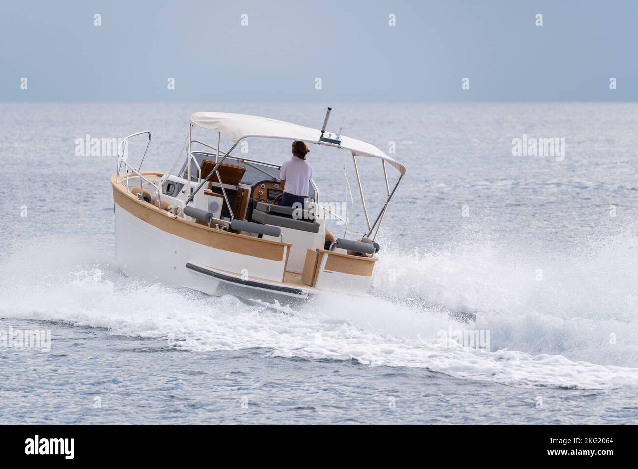 Little luxury boat sailing near the line coast Stock Photo - Alamy