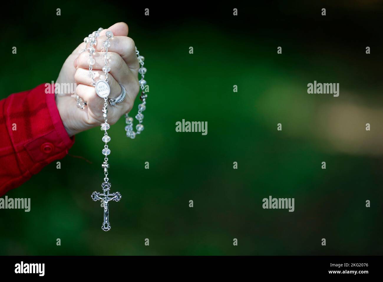 Catholic woman praying the Rosary. Close up on hand Stock Photo - Alamy