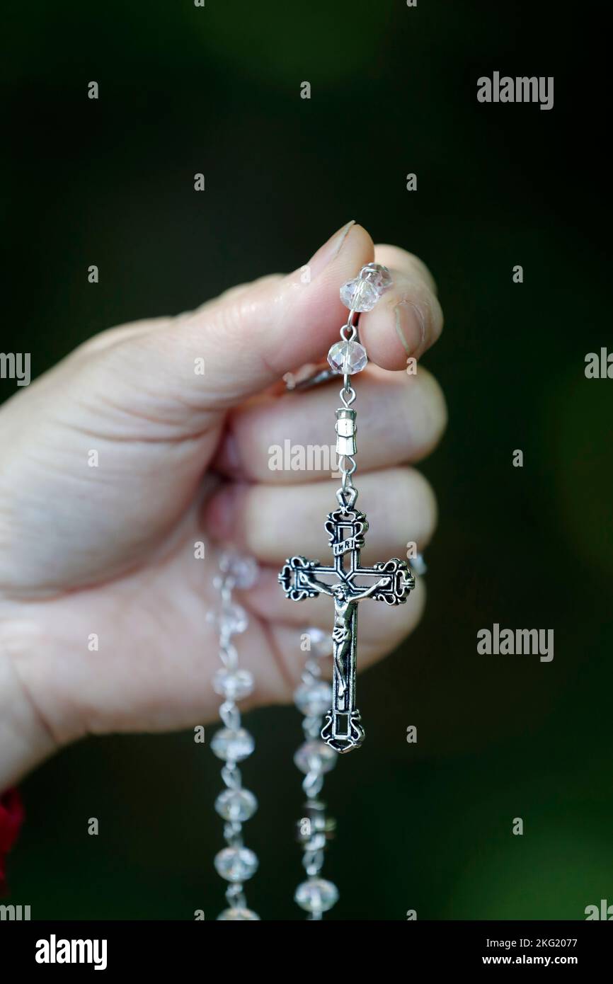Catholic woman praying the Rosary. Close up on hand Stock Photo - Alamy