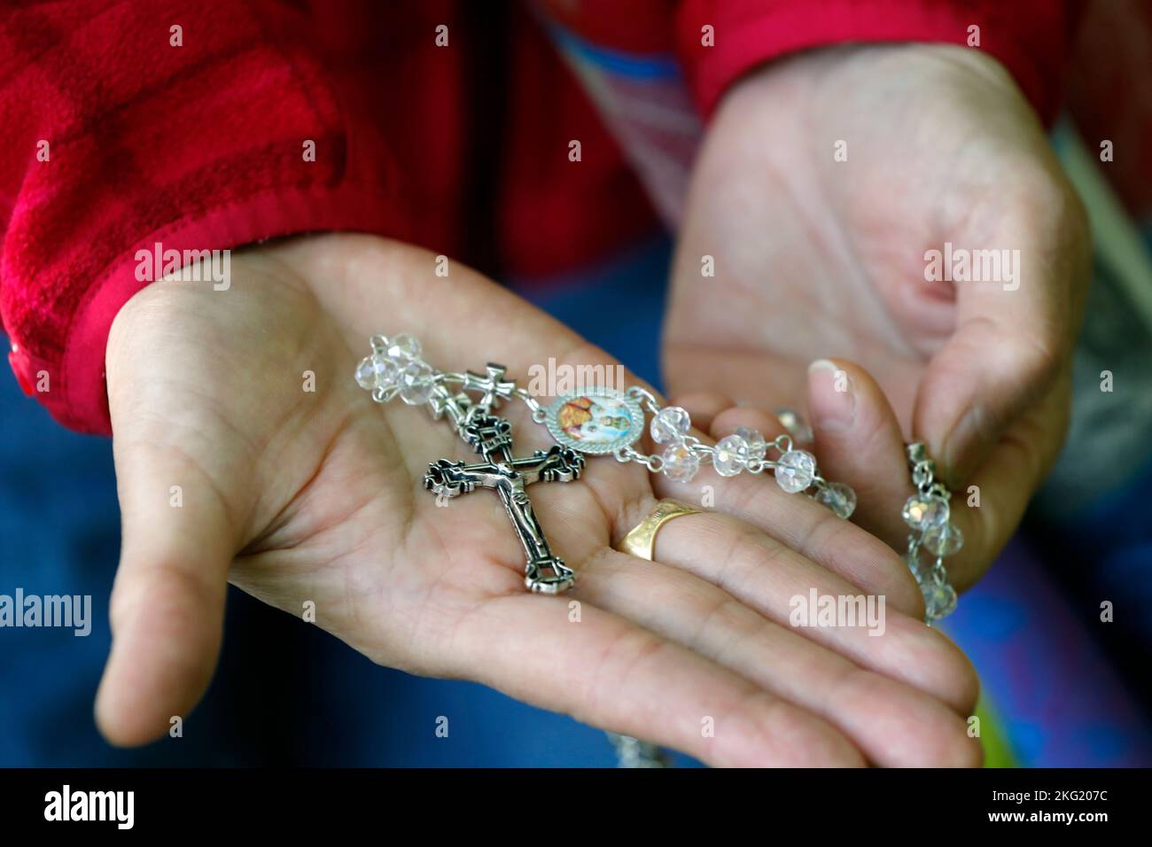 Catholic woman praying the Rosary. Close up on hand Stock Photo - Alamy