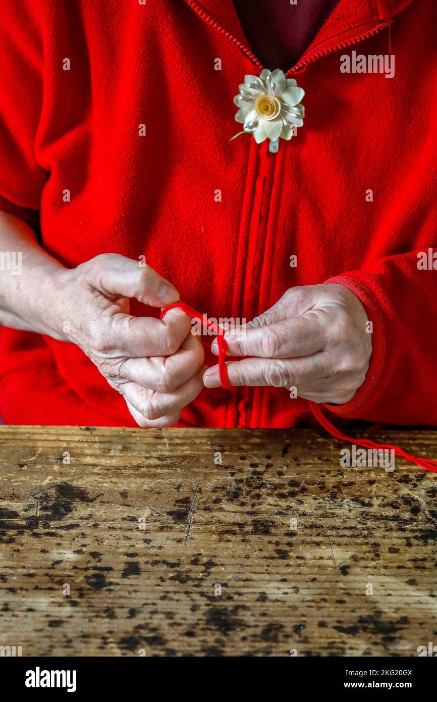 Hand woman tying thread hi-res stock photography and images - Alamy