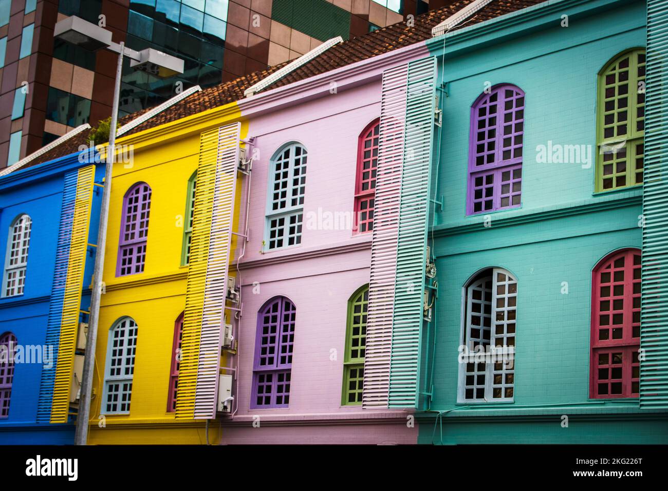 The facade of a bright house with colorful windows Stock Photo - Alamy