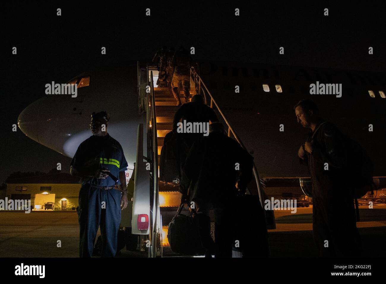 U.S. Air Force Airmen, assigned to the 23rd Wing, board an Omni Air ...