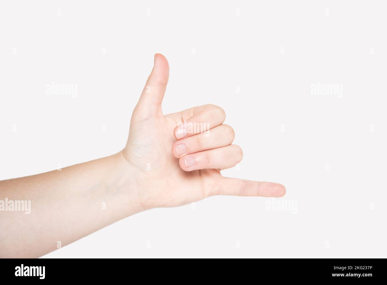 A closeup of a hand gesture call me isolated on a white background ...