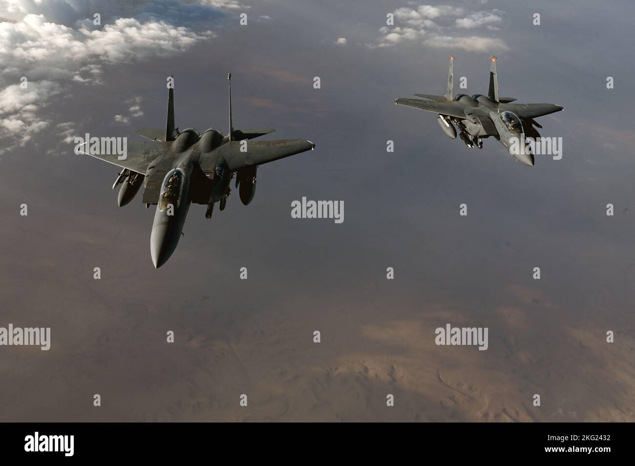 Two U.S. Air Force F-15E Strike Eagles fly in formation over an ...
