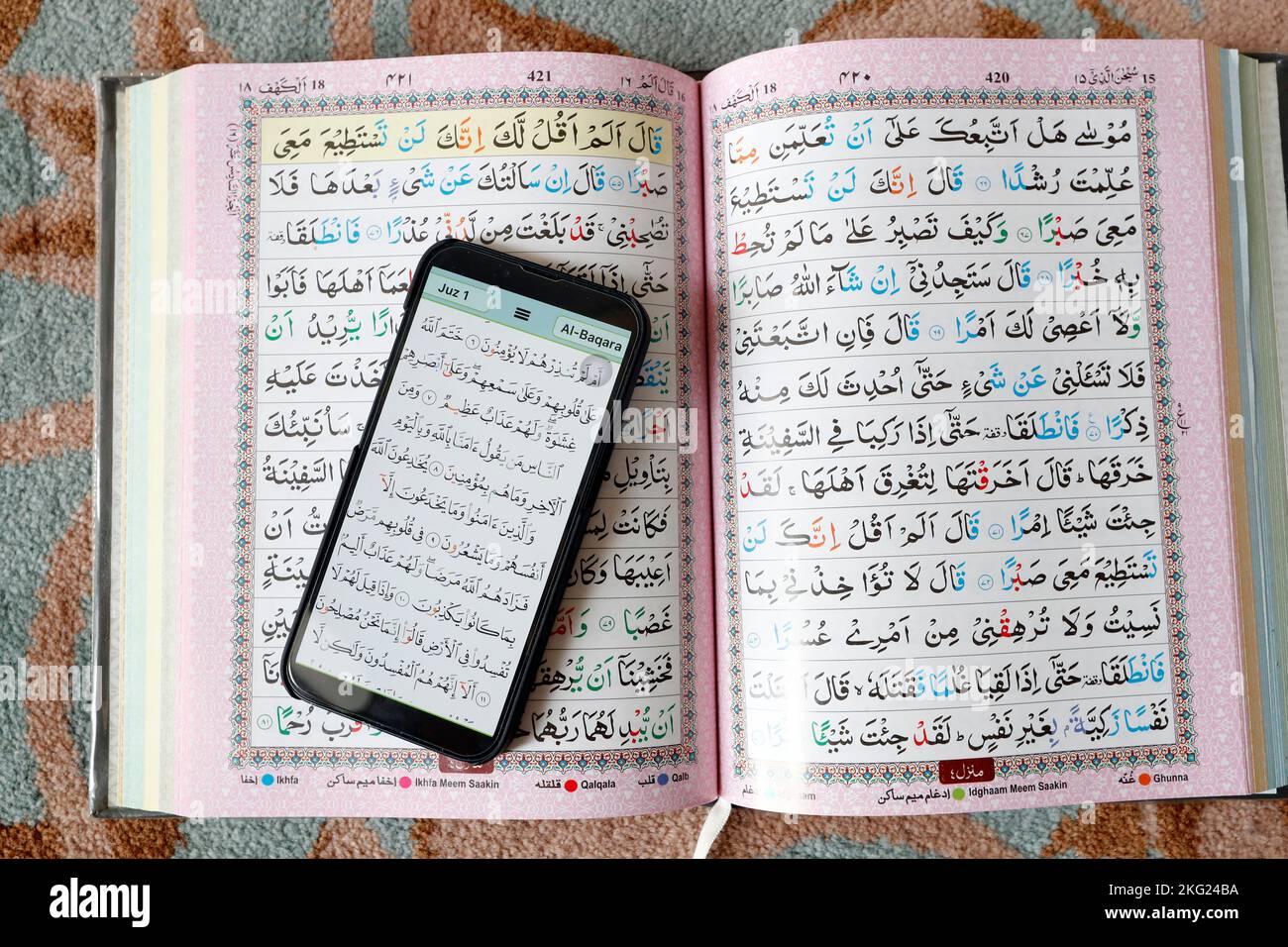 Al-Serkal Mosque. Digital Quran on a smartphone and traditional paper ...