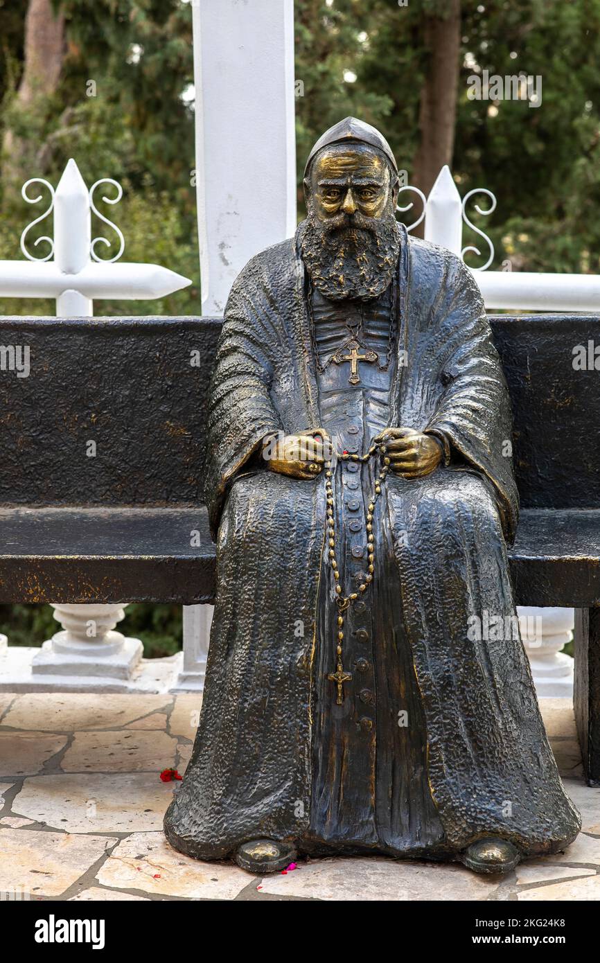 Statue of praying saint in Our Lady of Lebanon sanctuary, Harissa ...