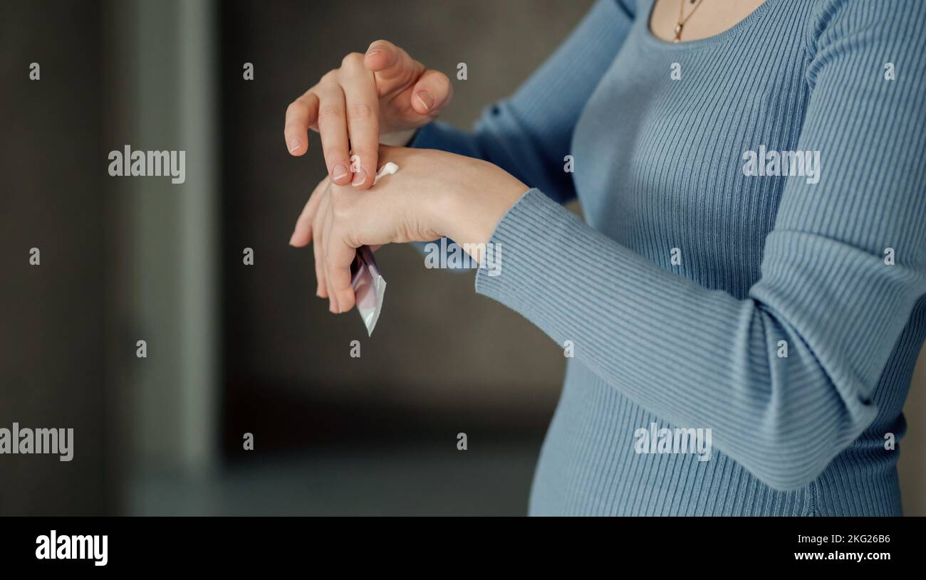 woman applying hand cream. Smooth female hands Stock Photo - Alamy