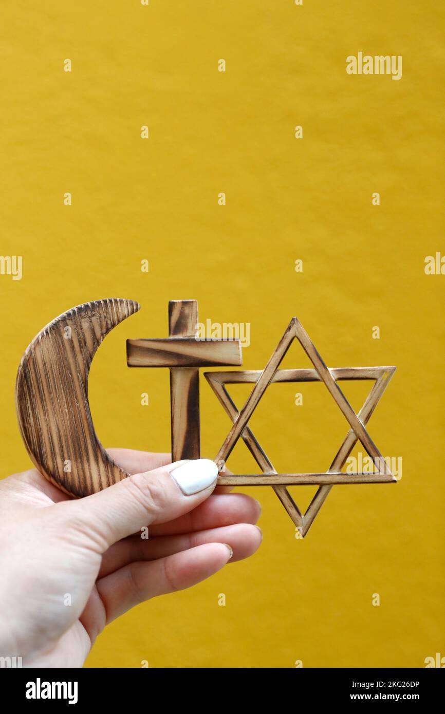 Religious symbols in hand. Jewish Star of David, Muslim star and ...