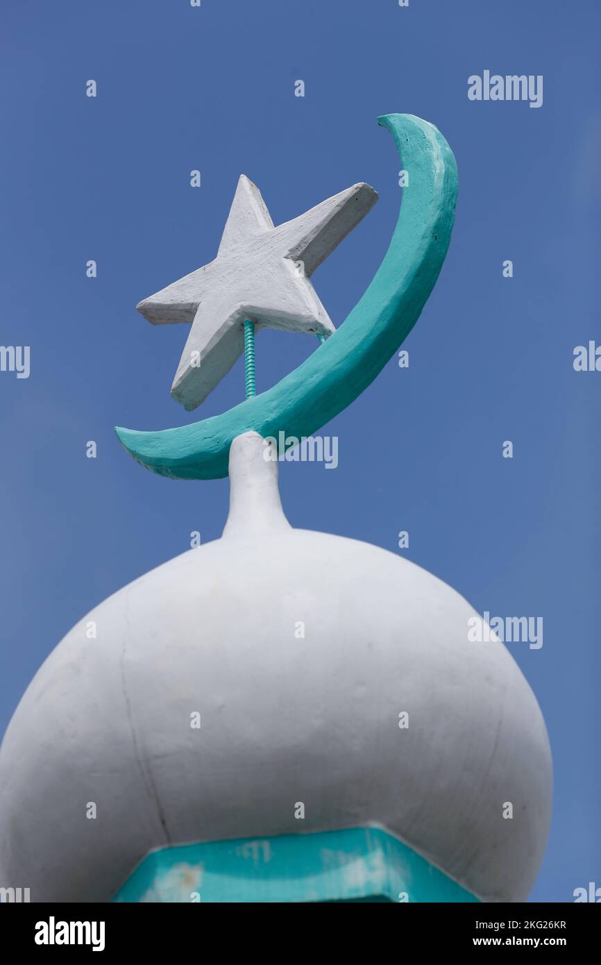 Minaret of a small mosque with islamic crescent and star. Symbol of ...