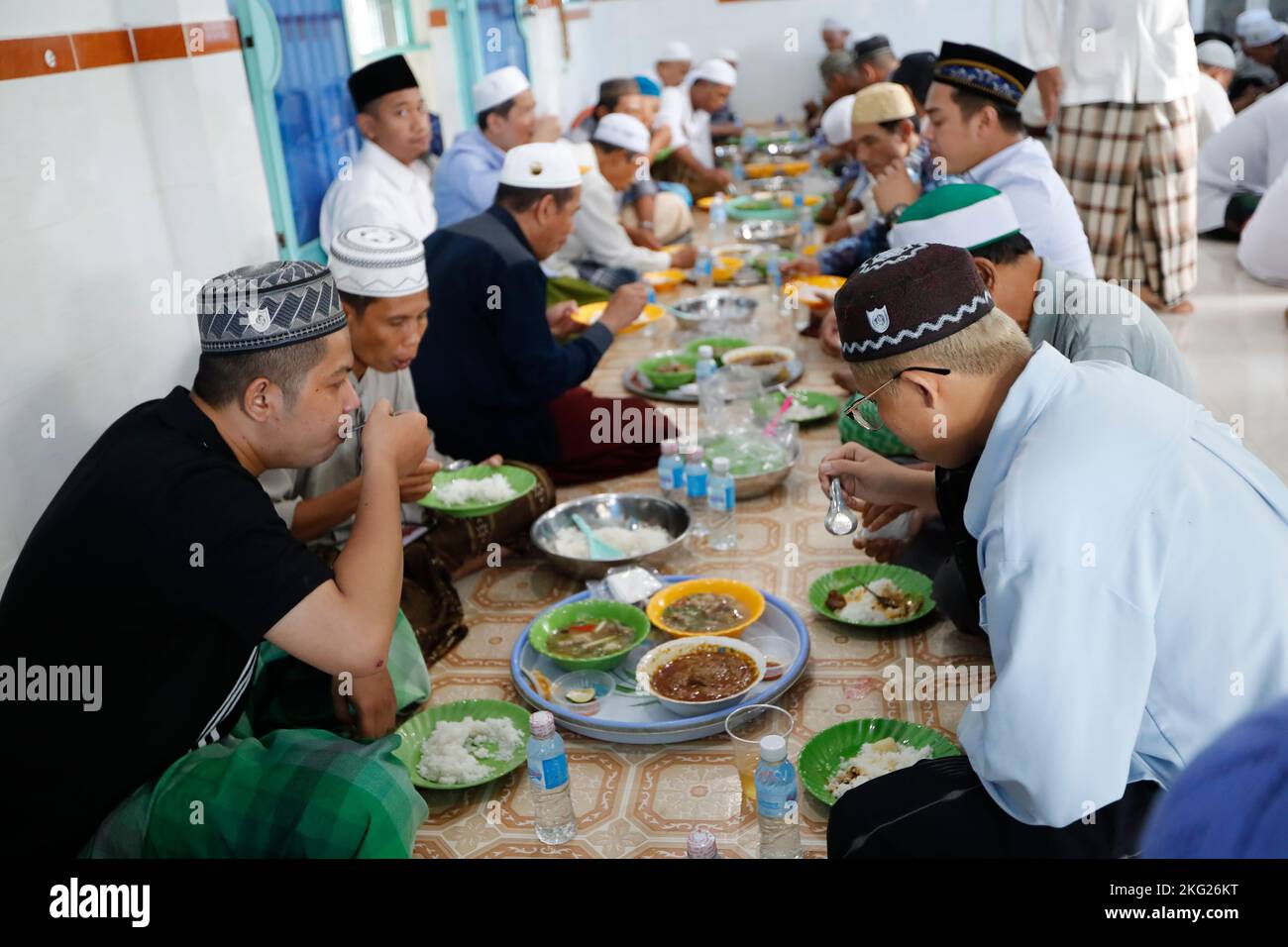 Muslim men sharing a free meal in mosque. Chau Doc. Vietnam Stock Photo ...