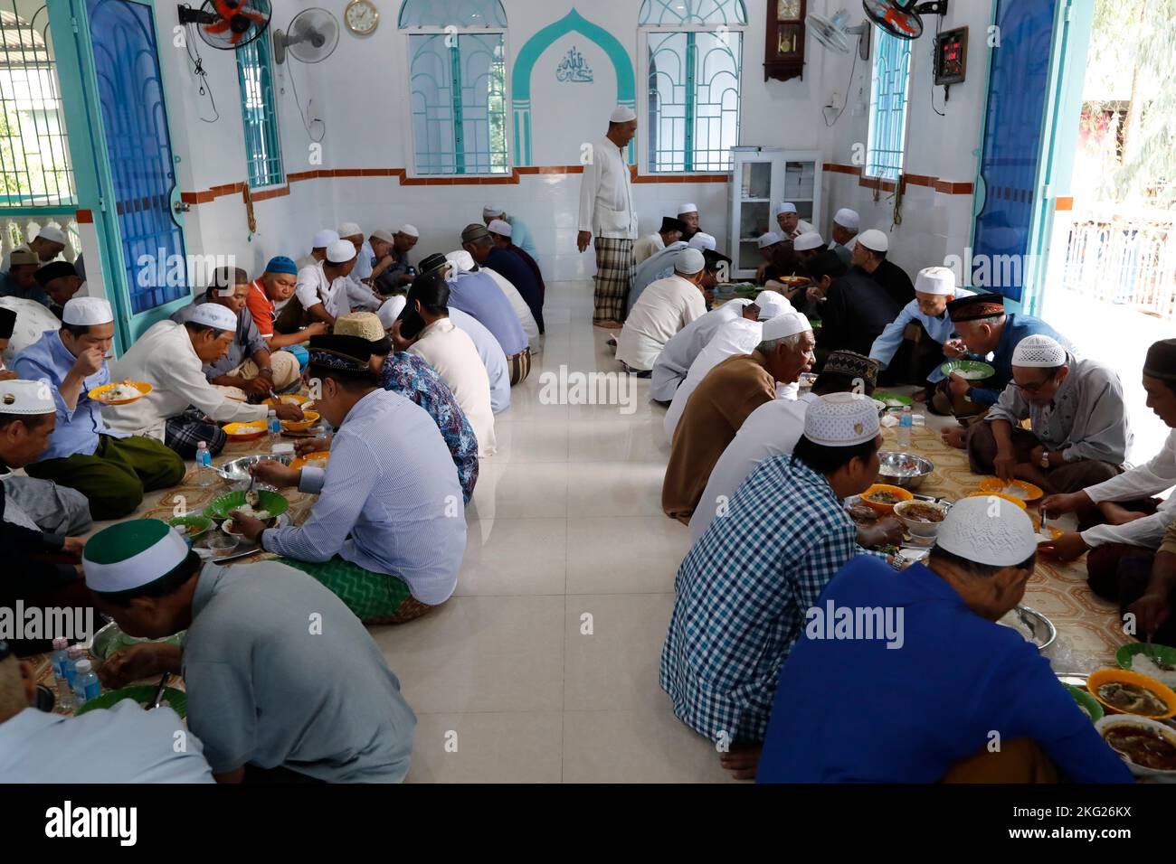 Muslim men sharing a free meal in mosque. Chau Doc. Vietnam Stock Photo ...