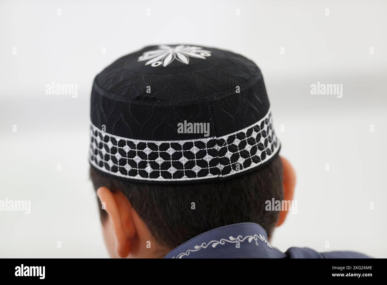 Muslim boy wearing a kufi. Friday prayer (salat) in mosque. Chau Doc ...