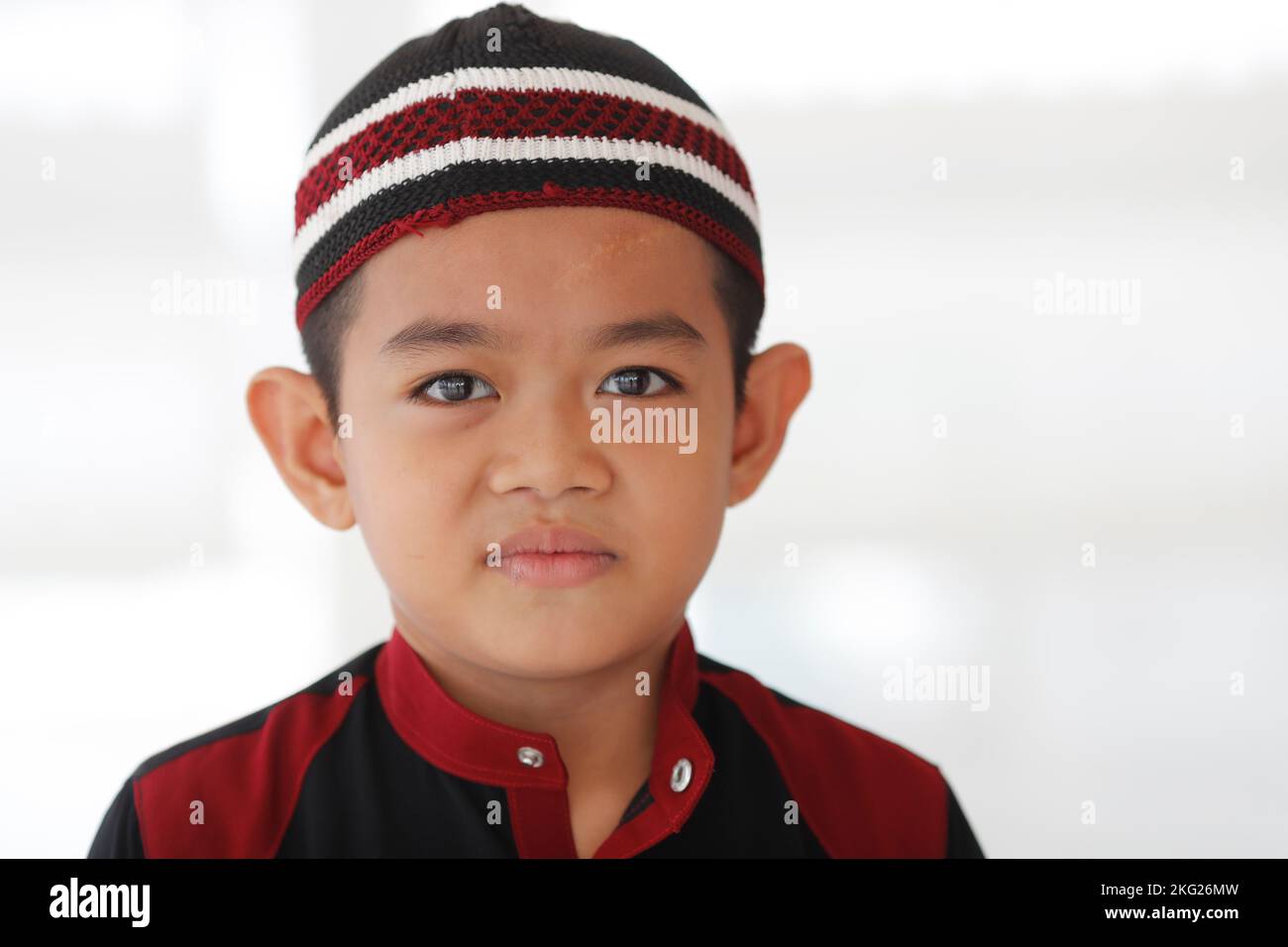 Muslim boy wearing a kufi. Friday prayer (salat) in mosque. Chau Doc ...