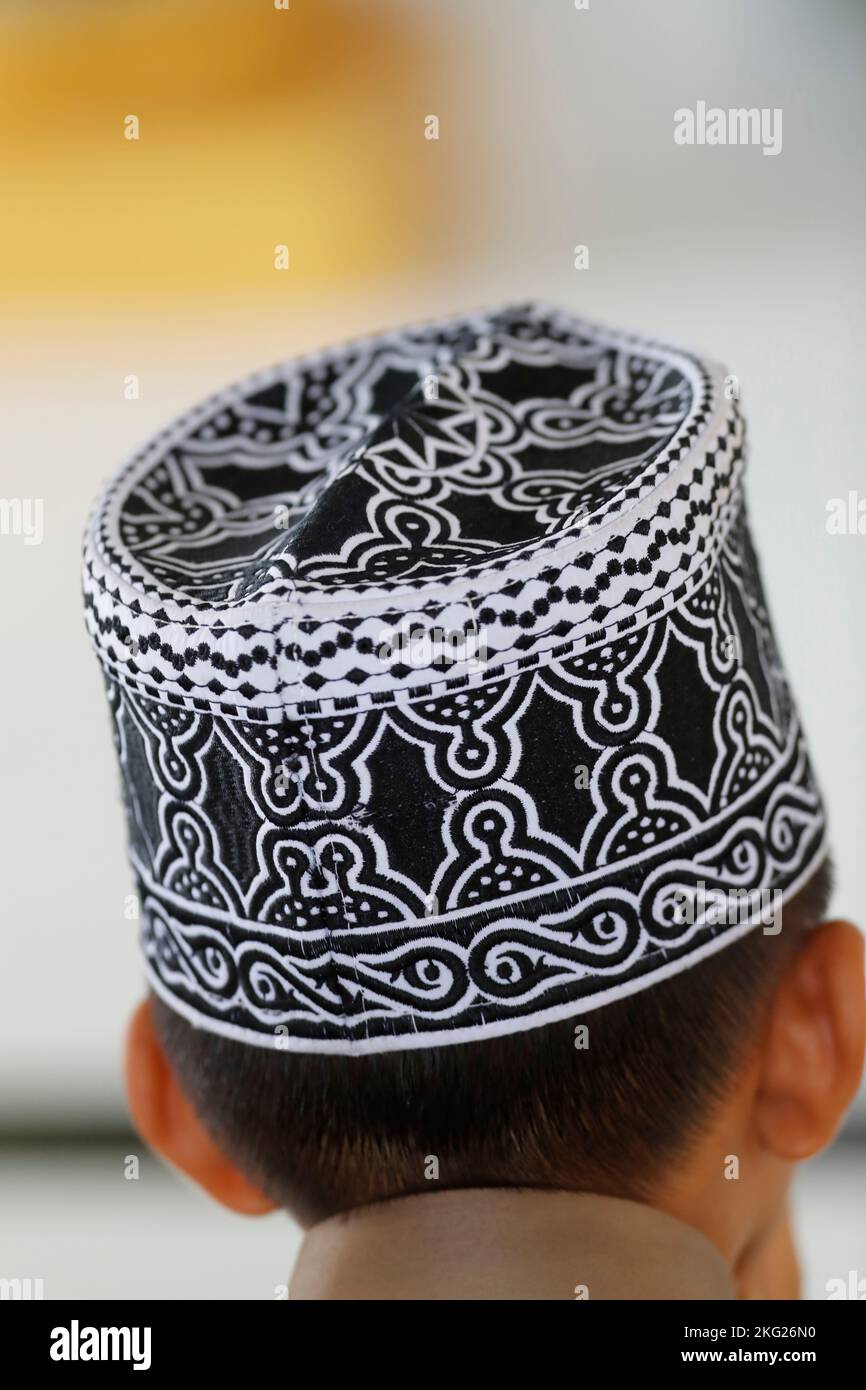 Muslim boy wearing a kufi. Friday prayer (salat) in mosque. Chau Doc ...