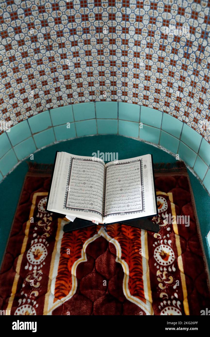 Mubarak mosque. Open Quran on wood stand. Symbol of Islam Stock Photo ...