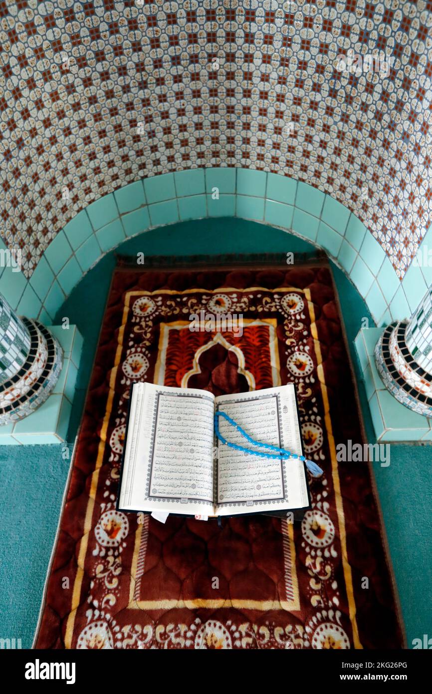 Mubarak mosque. Open Quran and muslim prayer beads on wood stand ...