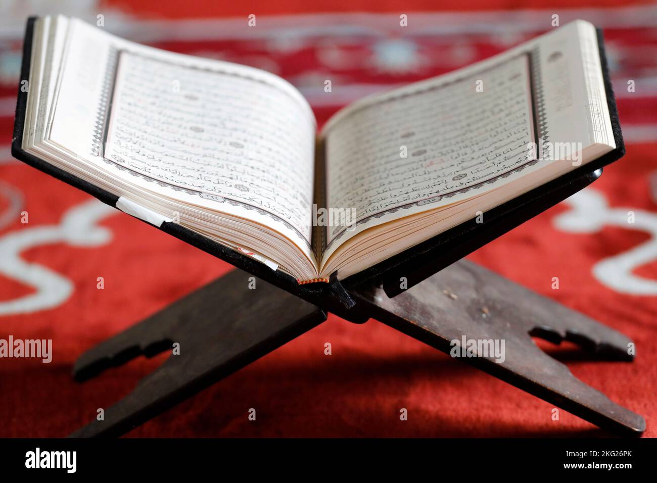 Open Quran on wood stand. Symbol of Islam Stock Photo - Alamy