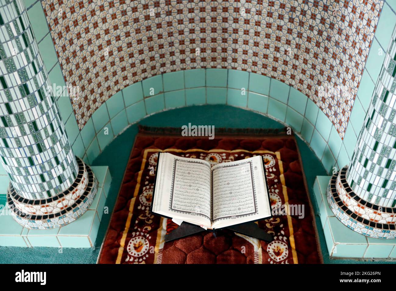 Mubarak mosque. Open Quran on wood stand. Symbol of Islam Stock Photo ...