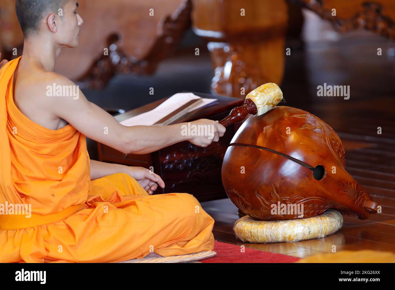 Ba Vang buddhist temple. Monk playing on a wooden fish (percussion ...