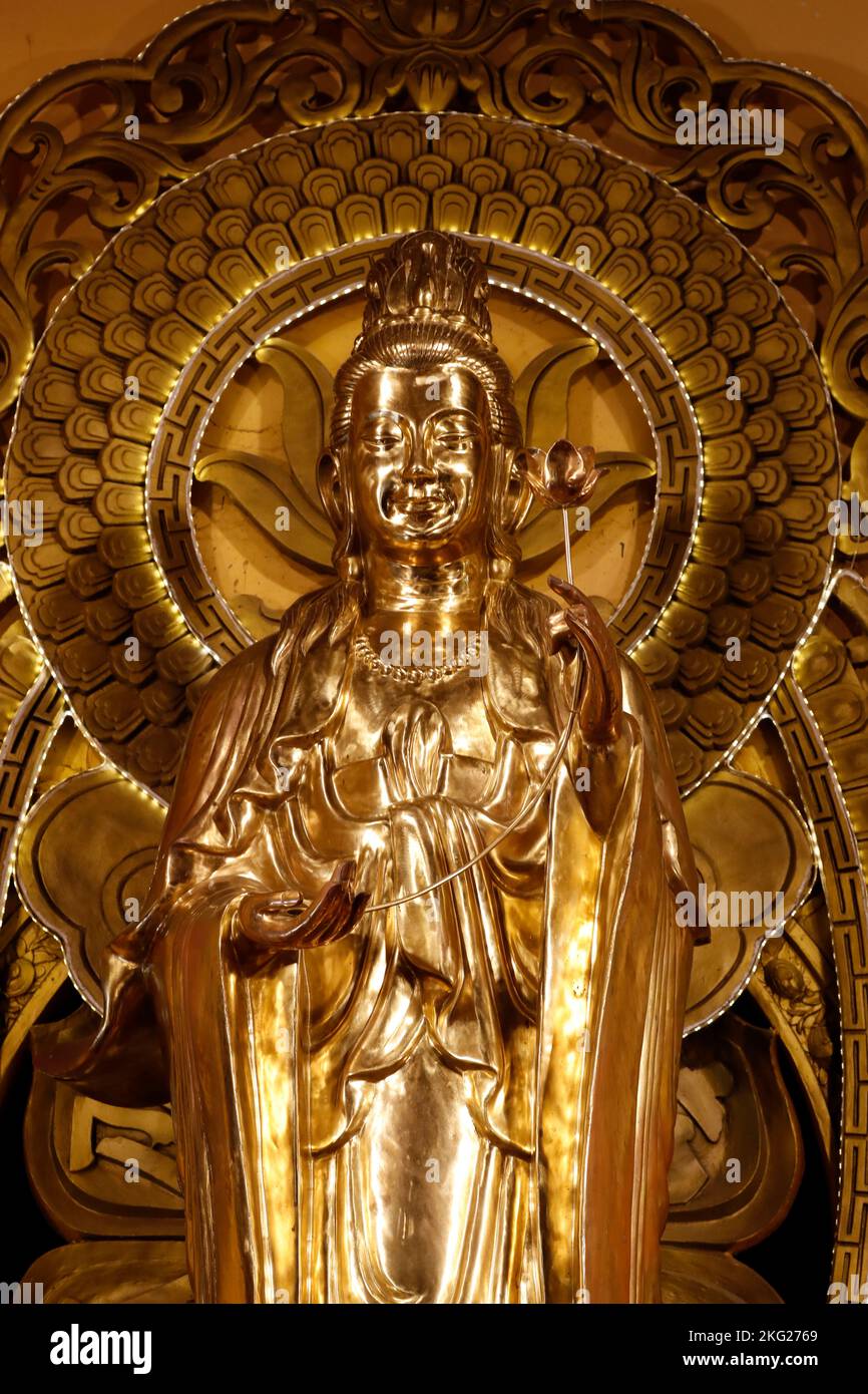 Long Duc buddhist temple. Main altar with Buddha statue. Avalokitesvara ...