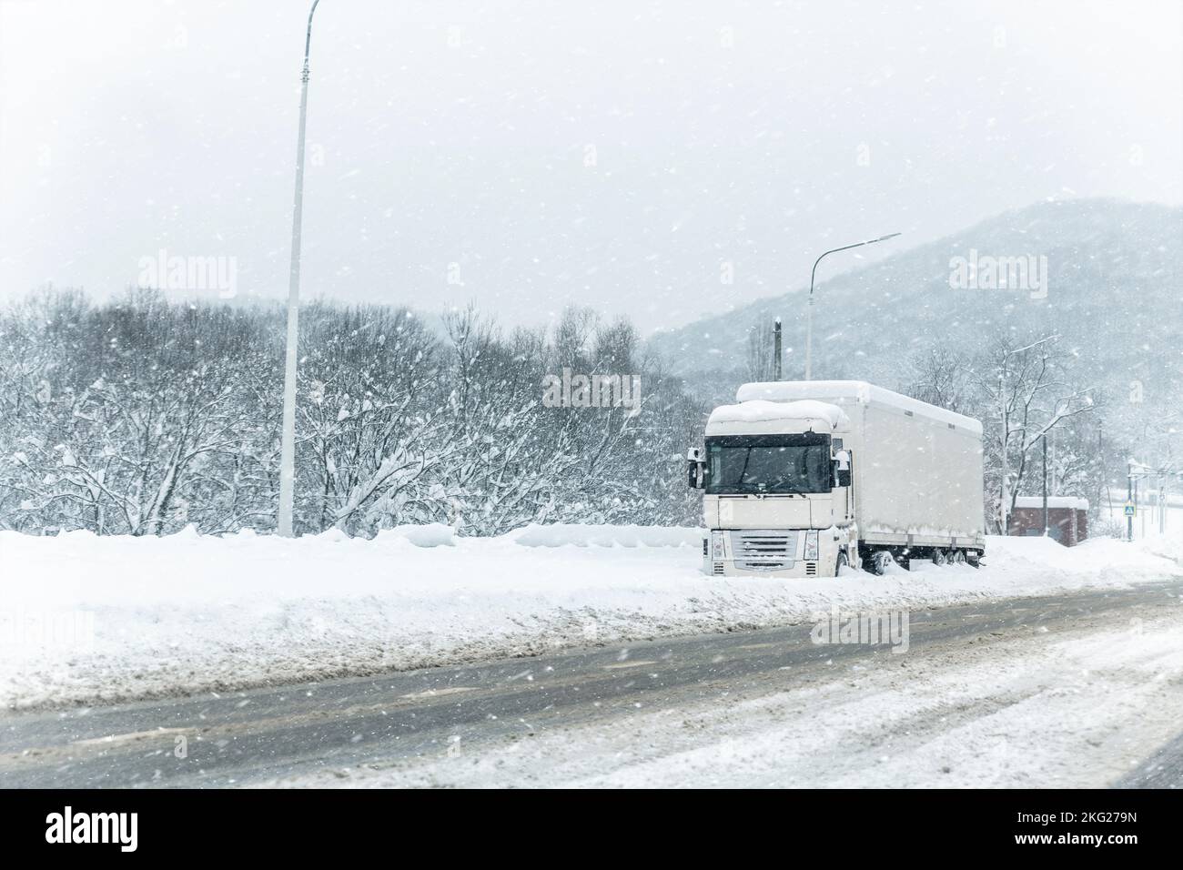 Big commercial semi-trailer truck trapped in snow drift on closed ...