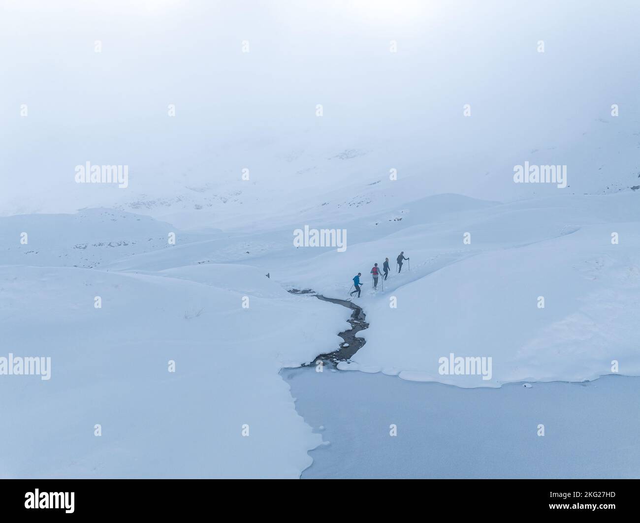 Aerial view of group of travelers exploring on the snow mountains Stock ...