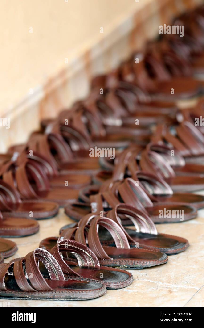 Ba Vang buddhist temple. Lether shoes at the entrance of the pagoda ...