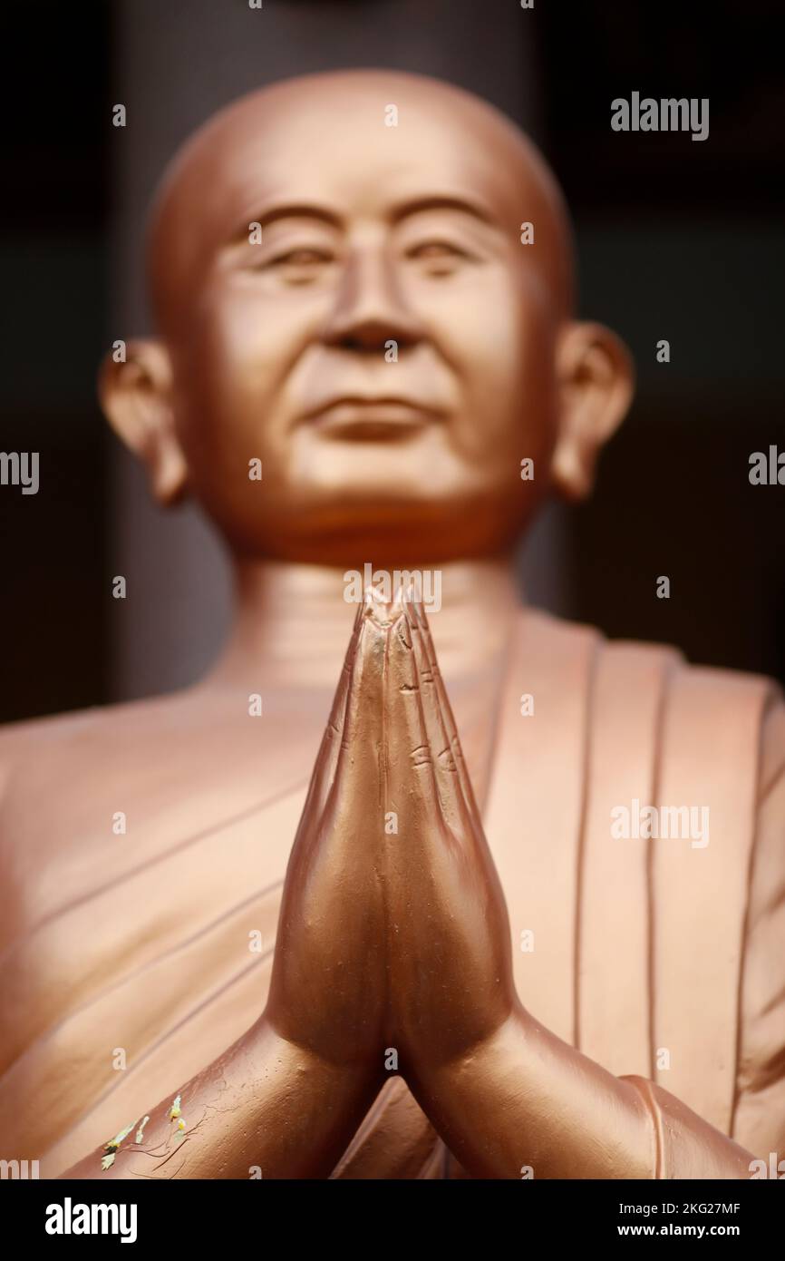 Phat Ngoc Xa Loi buddhist temple. Buddhist monk praying. Statue. Vinh ...