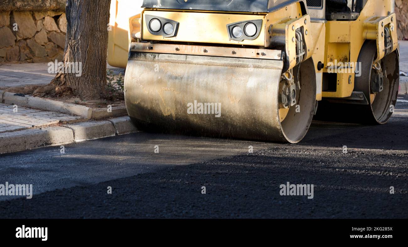 Road roller and asphalt paving machine at construction site Stock Photo ...