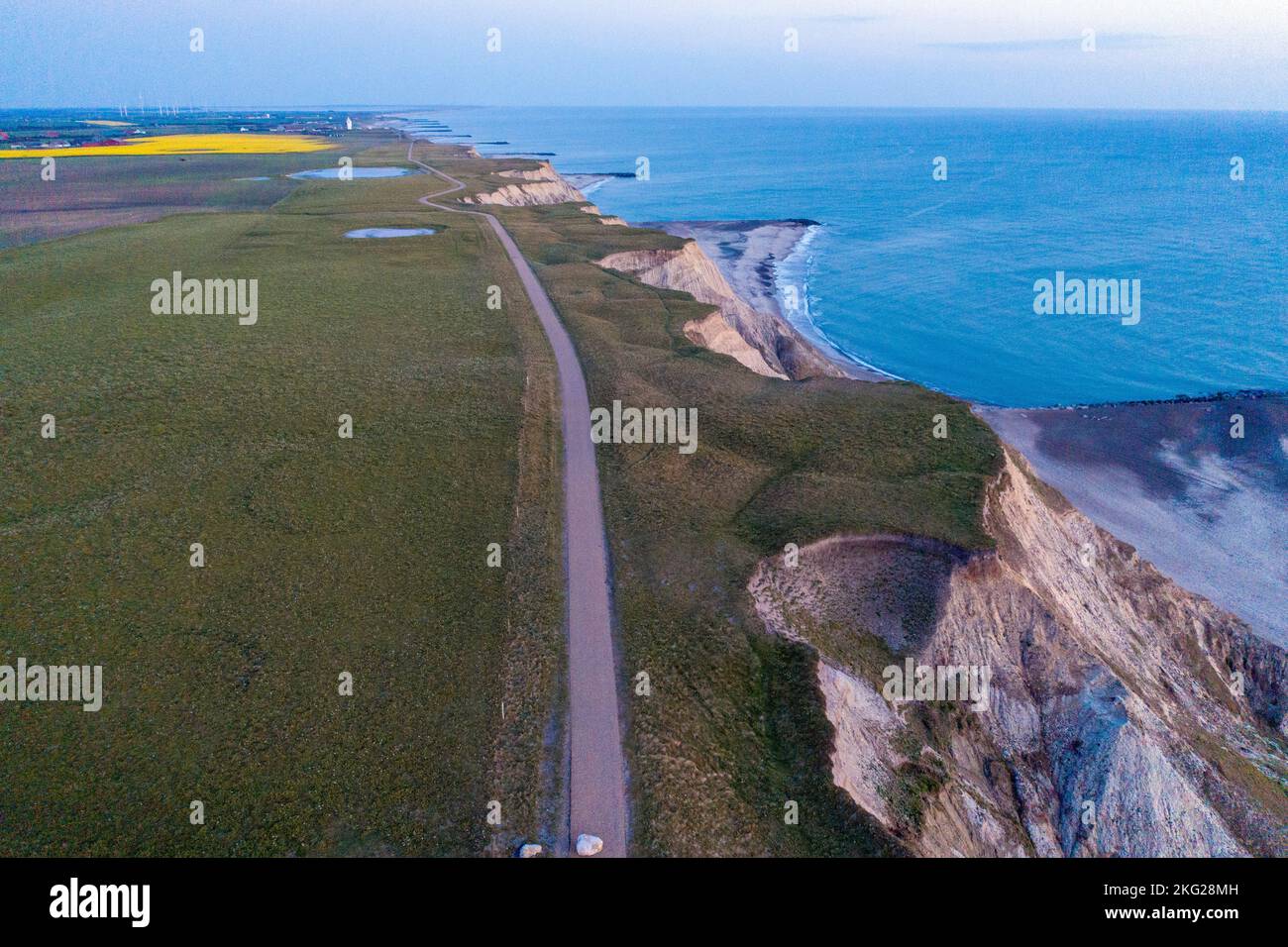The gradient blue sky over the sea and green fields against the blue ...