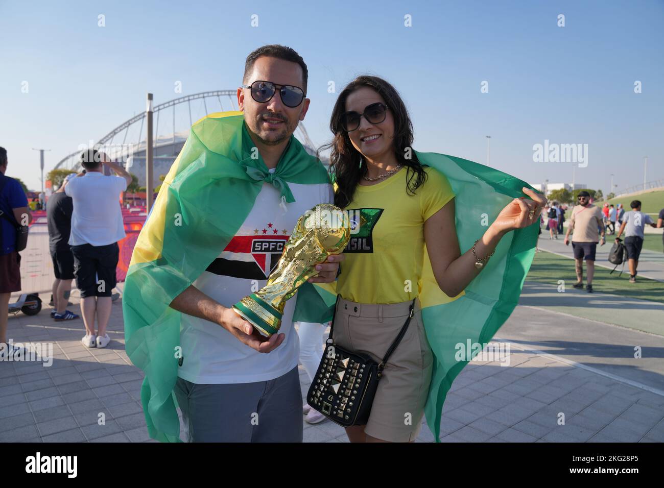 A Brazilian fan holds a replica of the FIFA World Cup trophy in Qatar ...