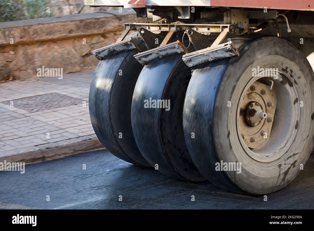 Road construction equipment coating asphalt black top lane Stock Photo ...