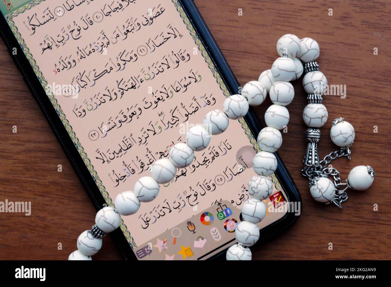 Digital Quran on a smartphone and muslim prayer beads. Digital Quran on ...