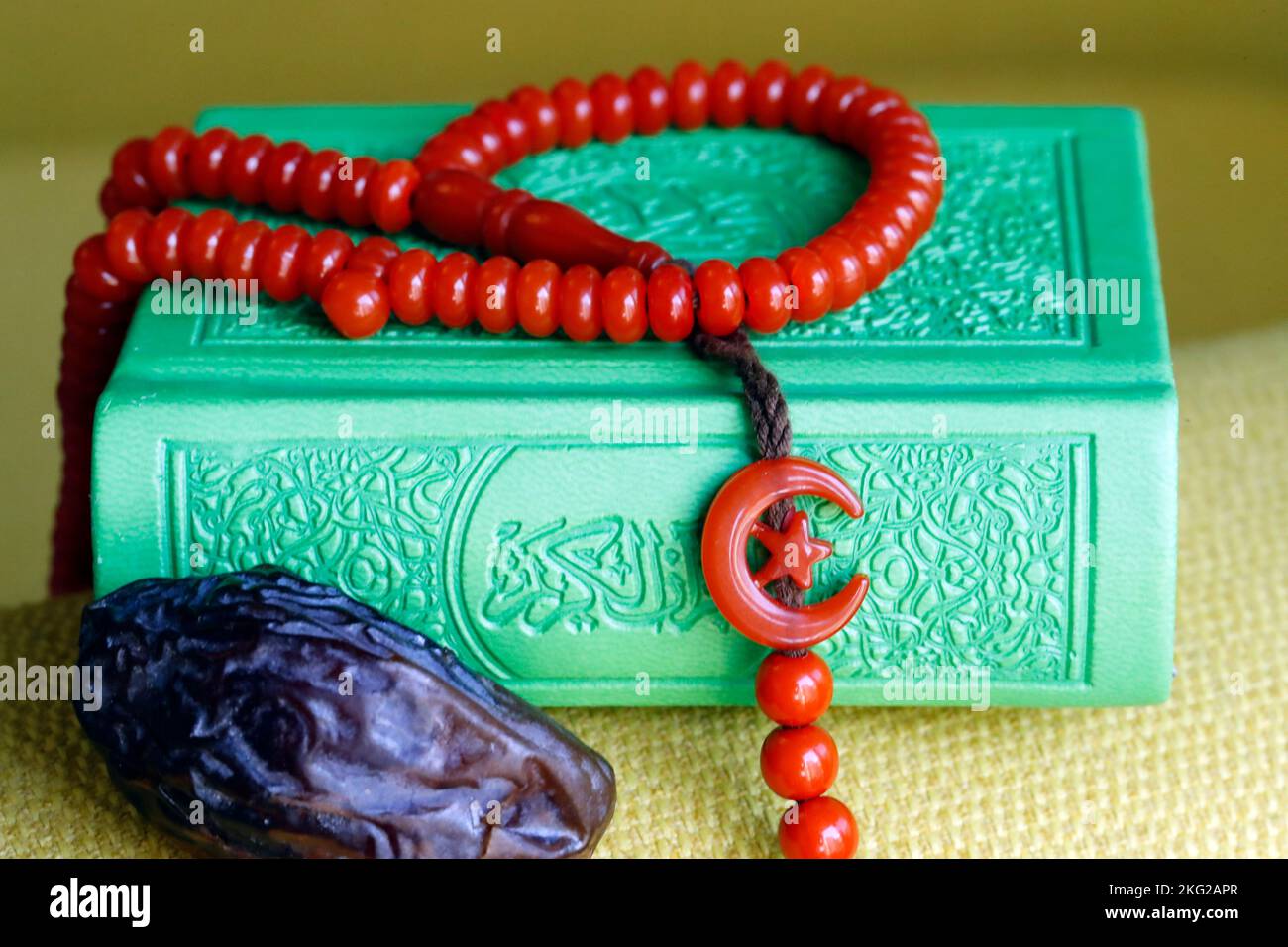 Holy Quran in arabic, muslim prayer beads, and fresh date. Islam ...