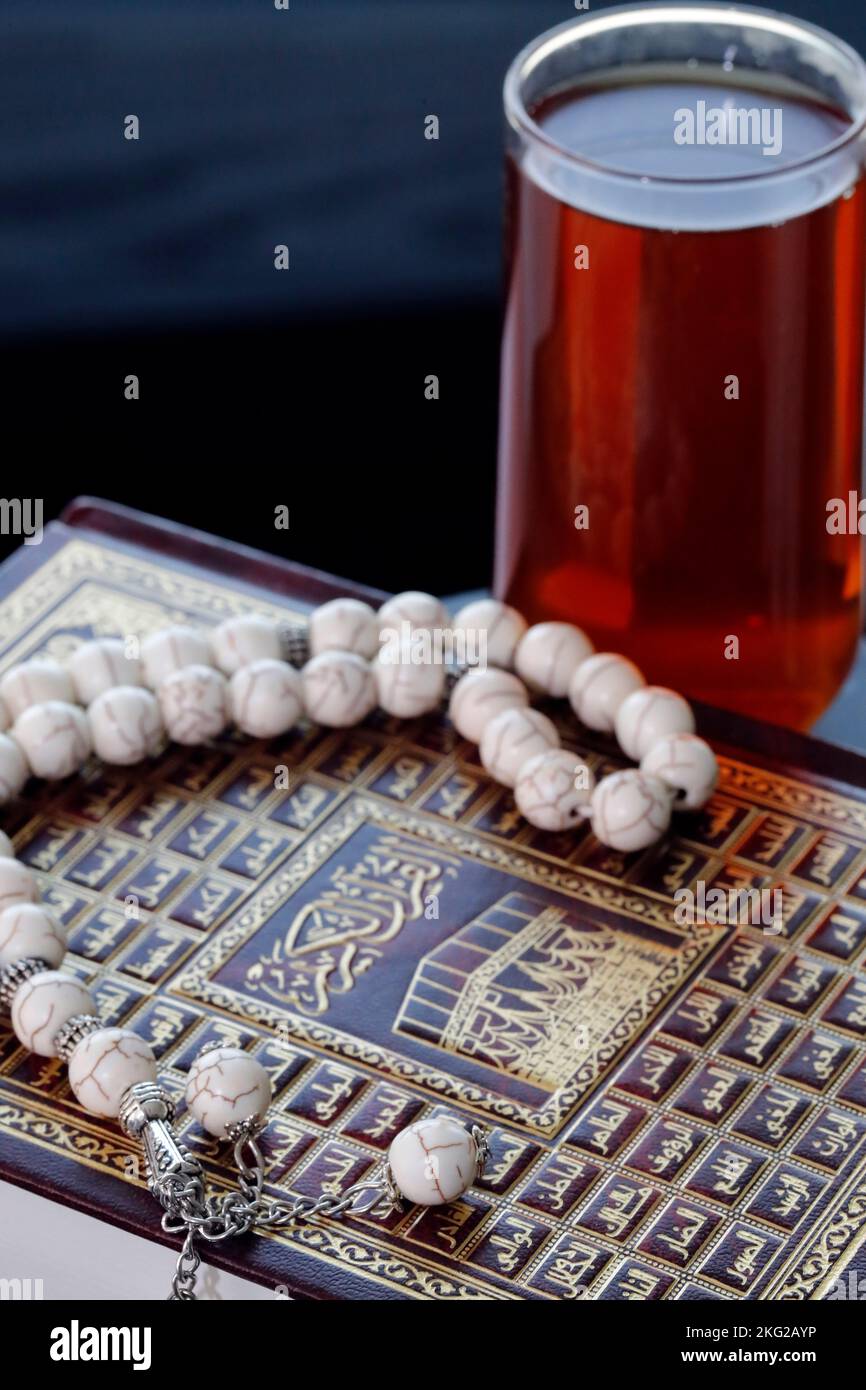 Holy Quran in arabic, muslim prayer beads, glass of tea. Islam symbols ...