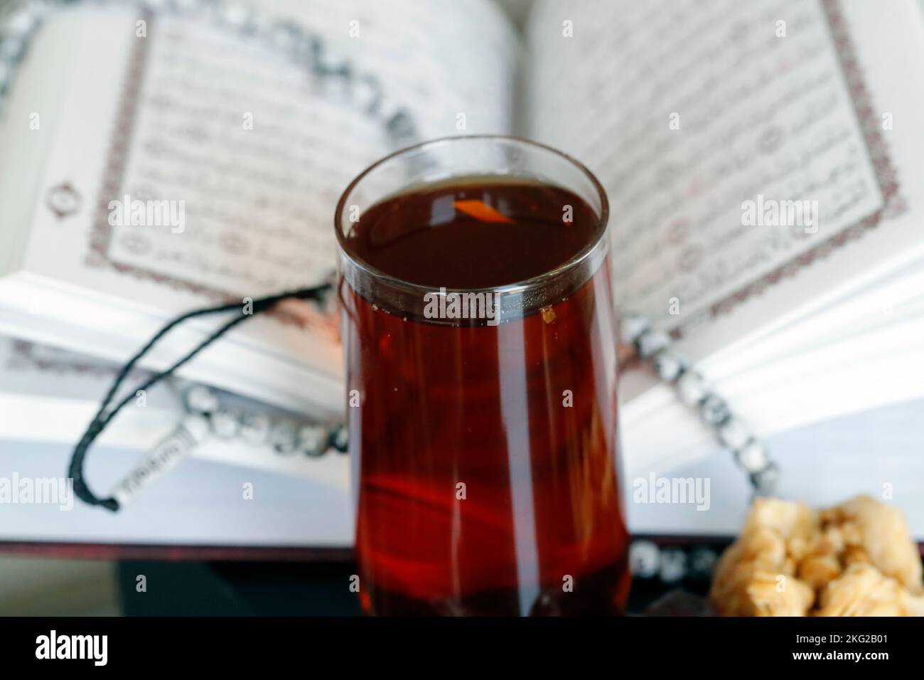 Holy Quran in arabic, muslim prayer beads, glass of tea. Islam symbols ...