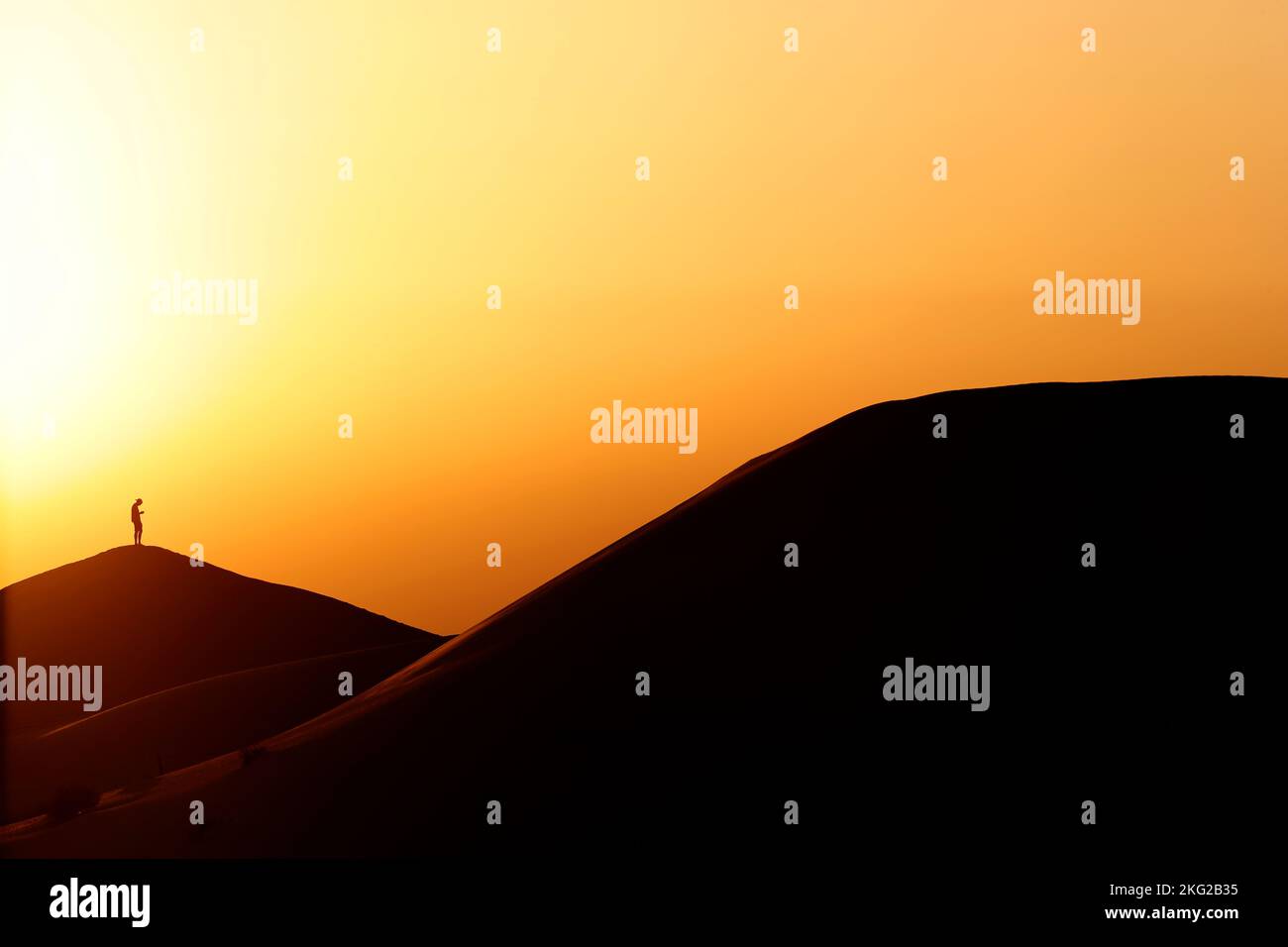 Silhouette on sand dune. Sunset meditation in the desert. Concept for ...