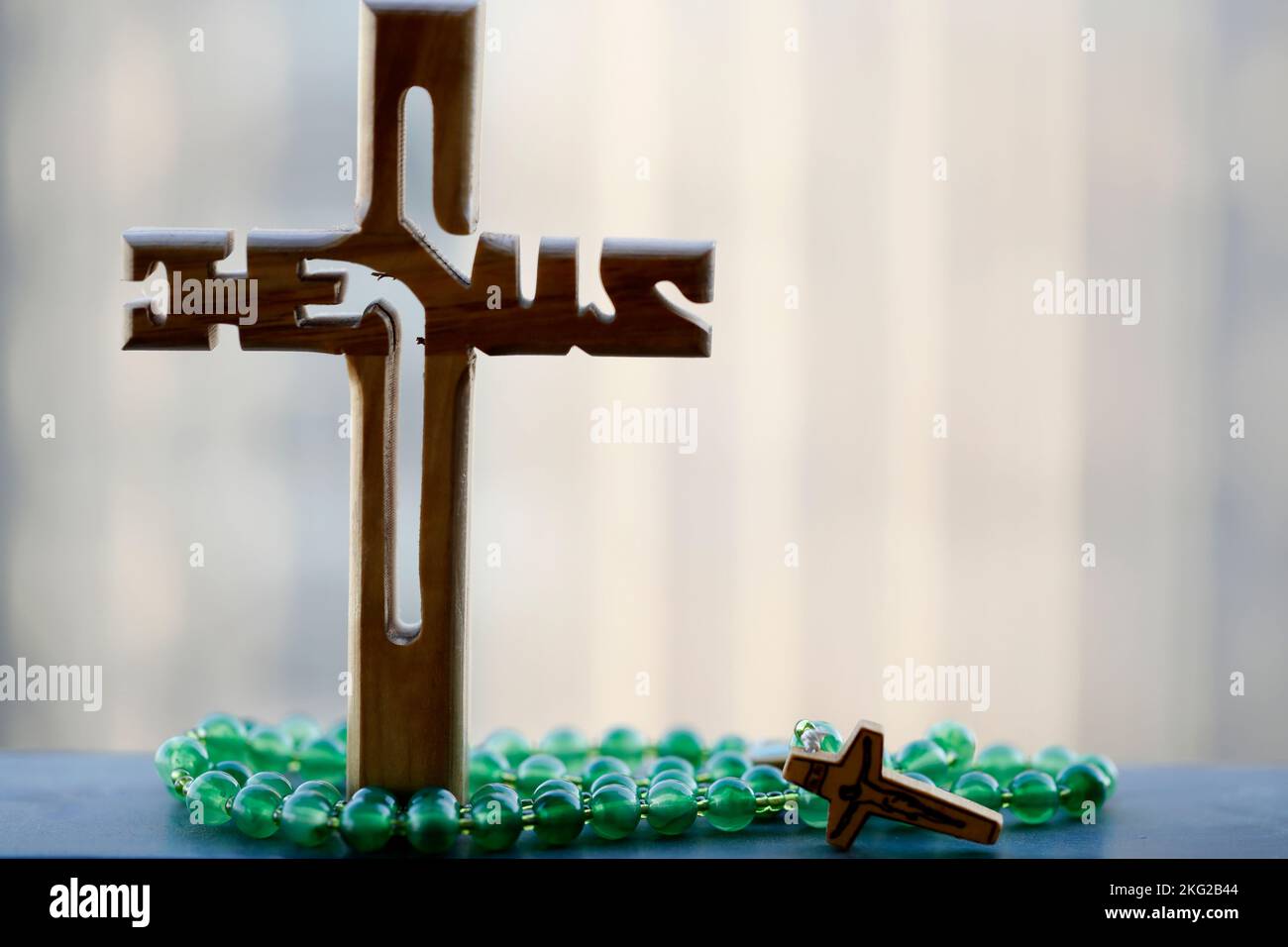 A wooden christian cross with the name of Jesus. Symbol of religion and ...