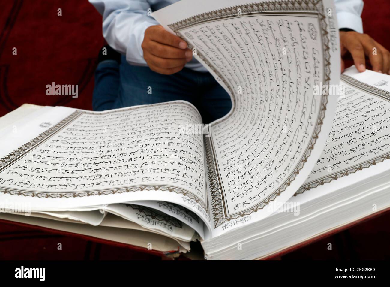 Muslim reading the Holy Quran. Close up on hand Stock Photo - Alamy