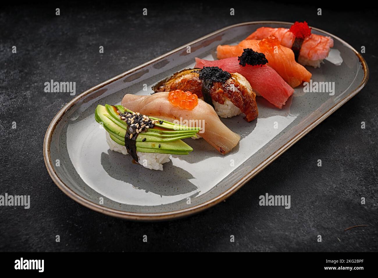 Assorted Nigiri sushi on a plate, on dark concrete. Top view Stock ...