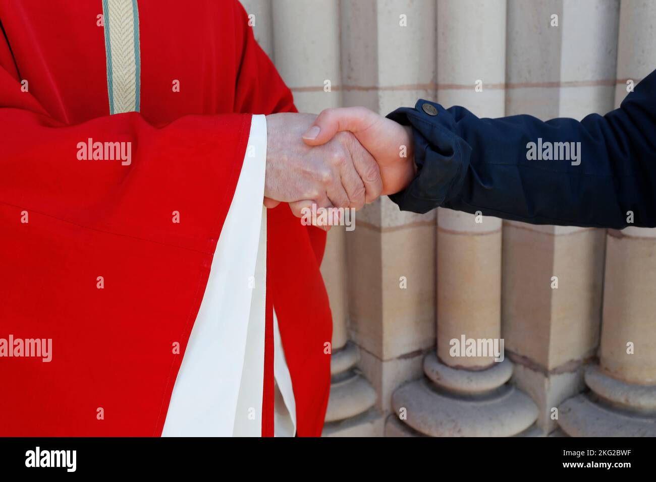 Catholic church. Catholic priest and a parishioner. Handshake ...